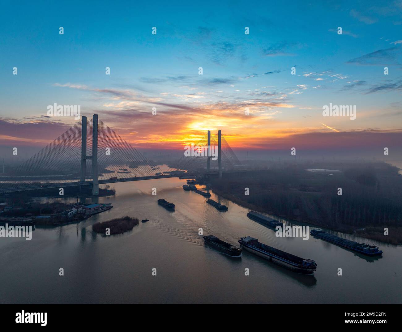 HUAI'AN, CHINA - DECEMBER 26, 2023 - Cargo ships sail in an orderly ...