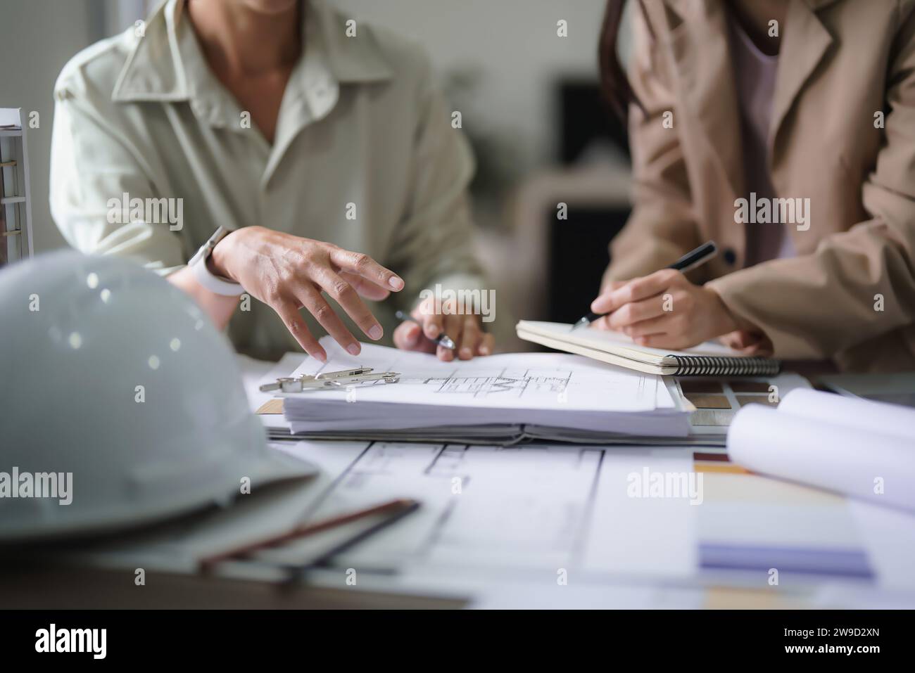 Two female architects discuss about interior design building project on ...