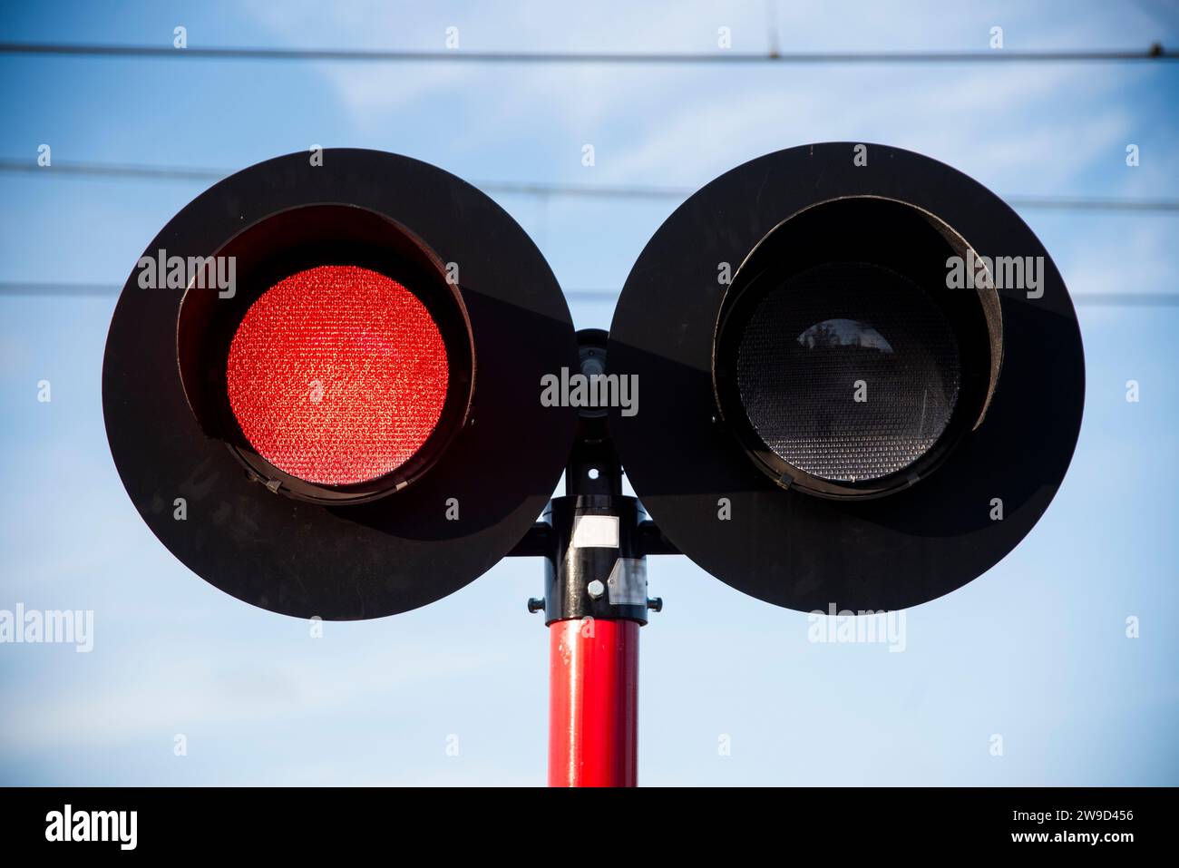 Red light at a railway crossing prohibiting passage Stock Photo - Alamy