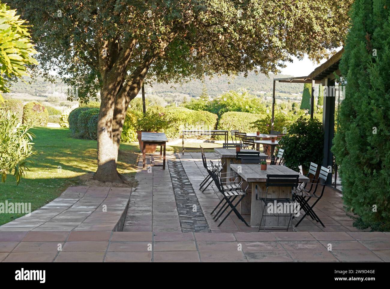 Spain. Summer area of a beautiful restaurant. Spanish cafe tables. Lots ...