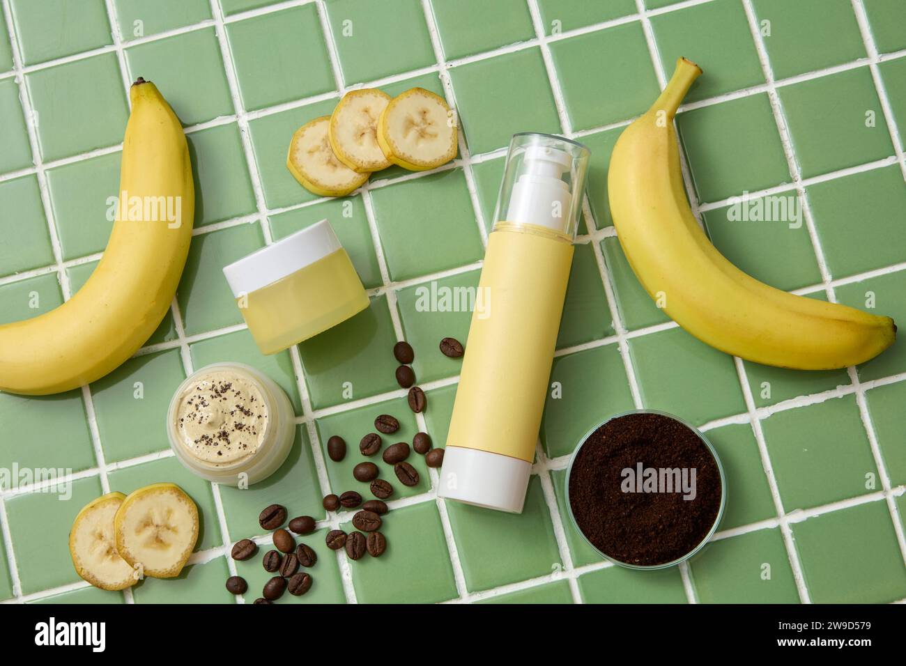 On the green ceramic background, set of cosmetic bottles displayed with ...