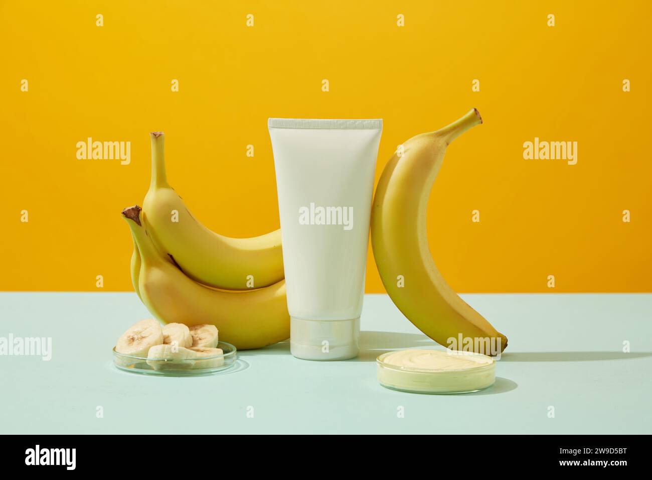 An white tube decorated with ripe bananas, banana slices and cream on ...