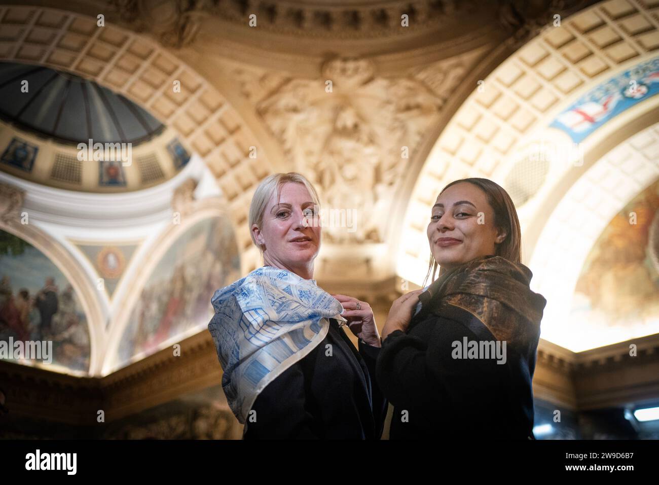 Members of the court staff stand in the Old Bailey wearing silk scarves ...