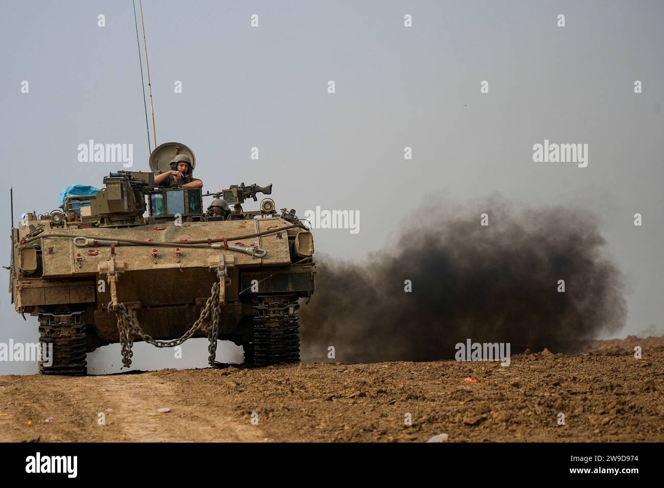 An Israeli armoured personnel carrier (APC) moves near the Gaza Strip ...