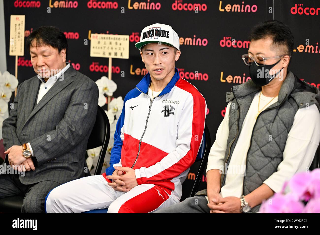 Naoya Inoue (center) of Japan talks to the media with his trainer and ...
