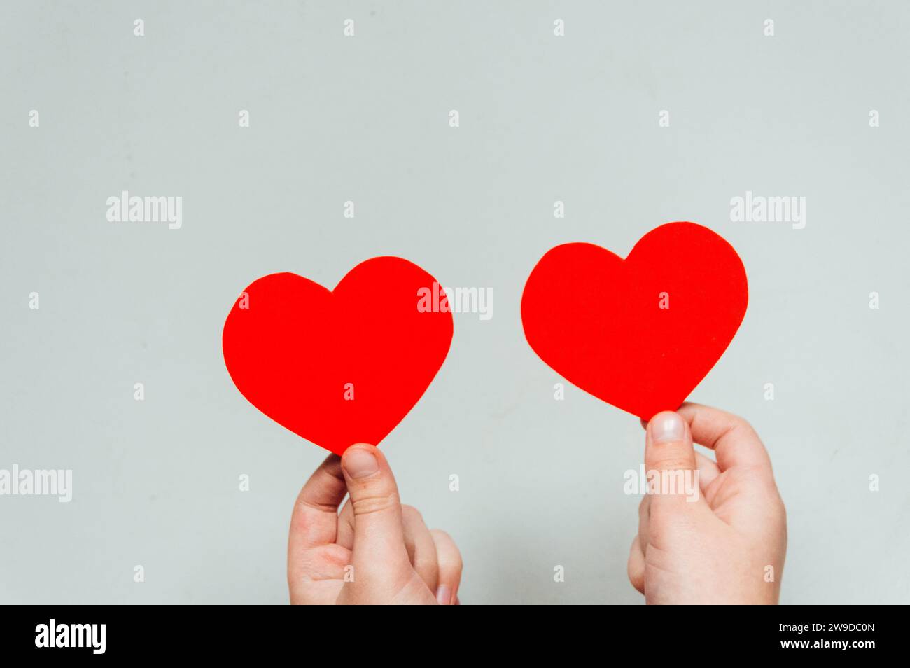 Red heart in children's hands on white background Stock Photo - Alamy