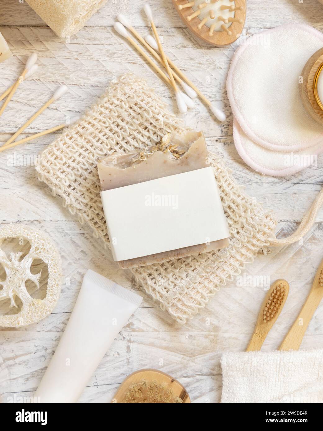 Organic handmade beige soap bar with blank label on soap saver bag near ...