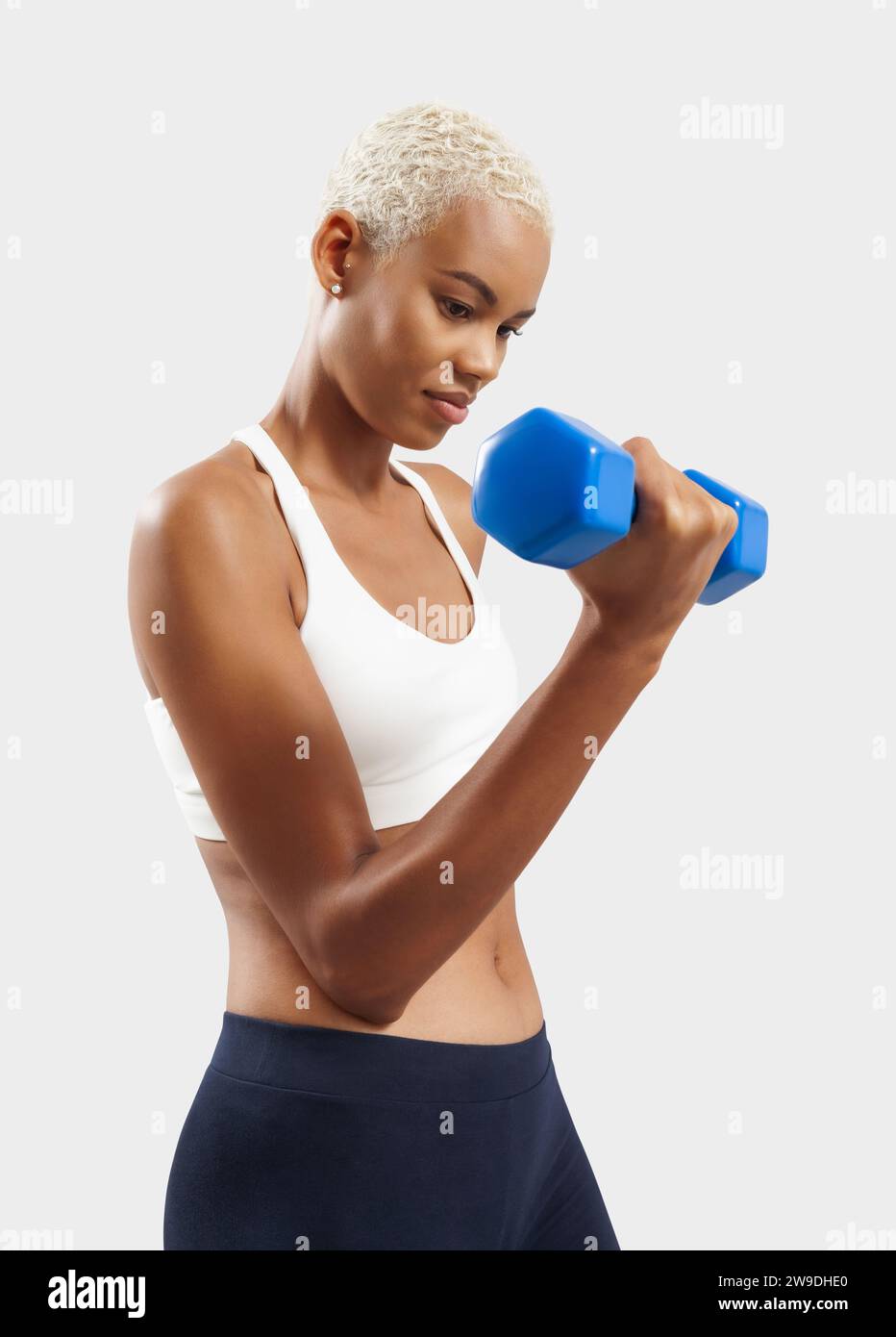 Latin American woman lifts dumbbells, young female athlete doing ...