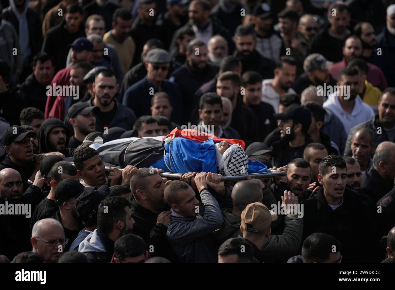 Palestinians carry the body of one that was killed after an Israeli ...