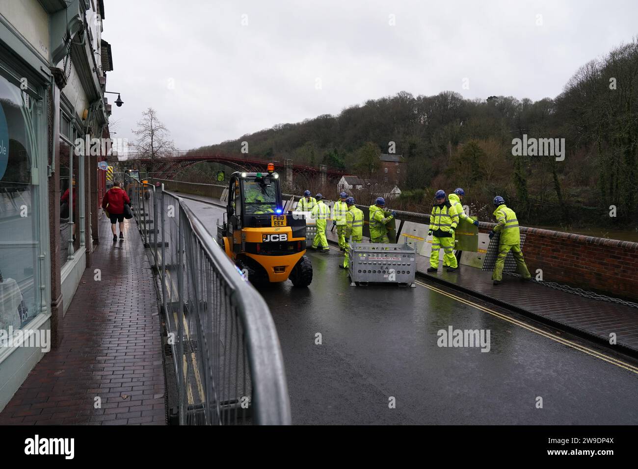 The swollen River Severn as flood defences are put in place along the ...