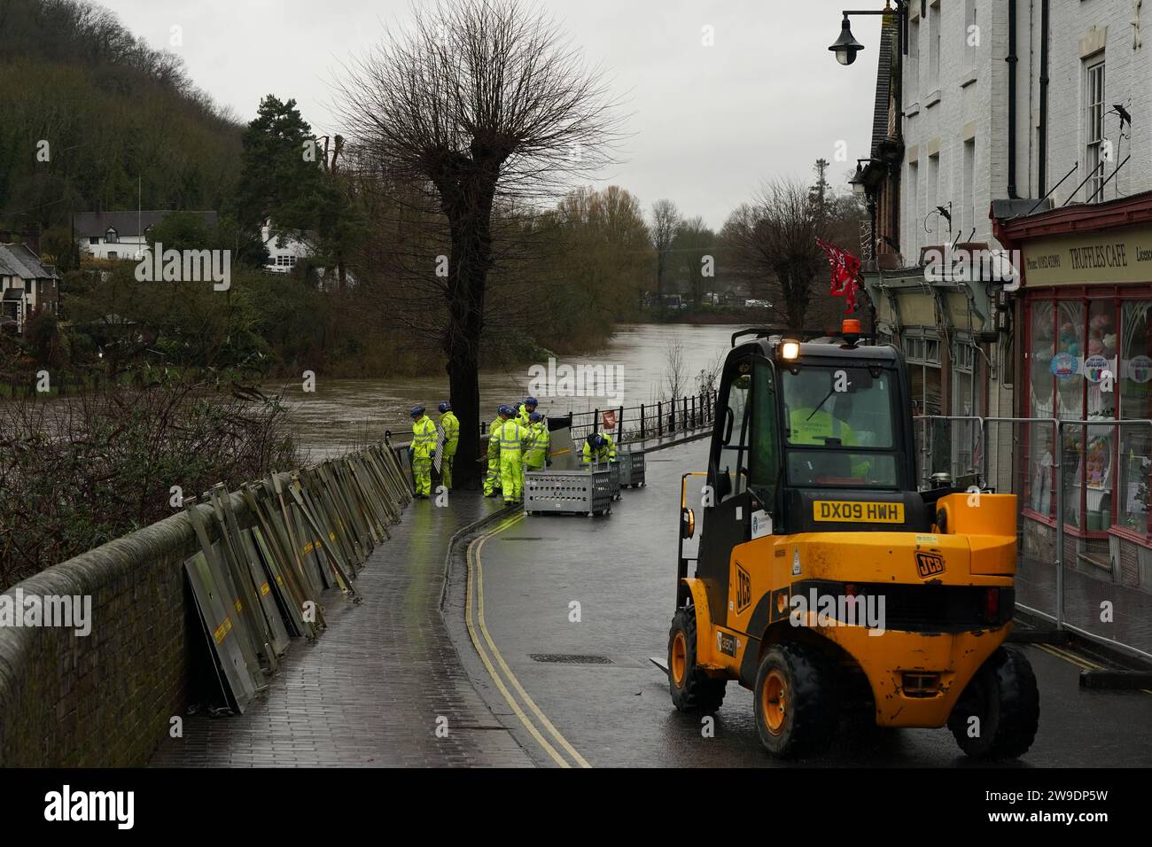 The swollen River Severn as flood defences are put in place along the ...