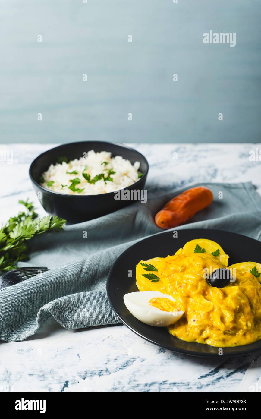 Traditional dish called aji de gallina with a portion of rice ...