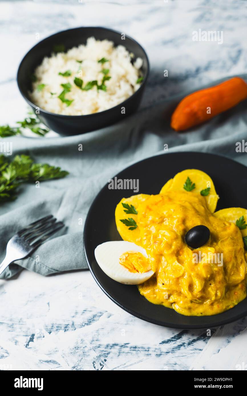 Traditional dish called aji de gallina with a portion of rice ...