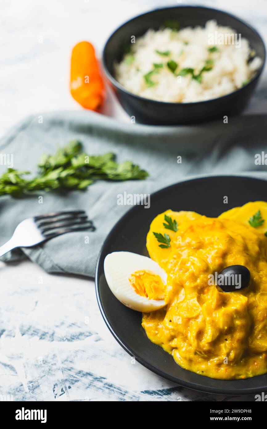 Traditional dish called aji de gallina with a portion of rice ...