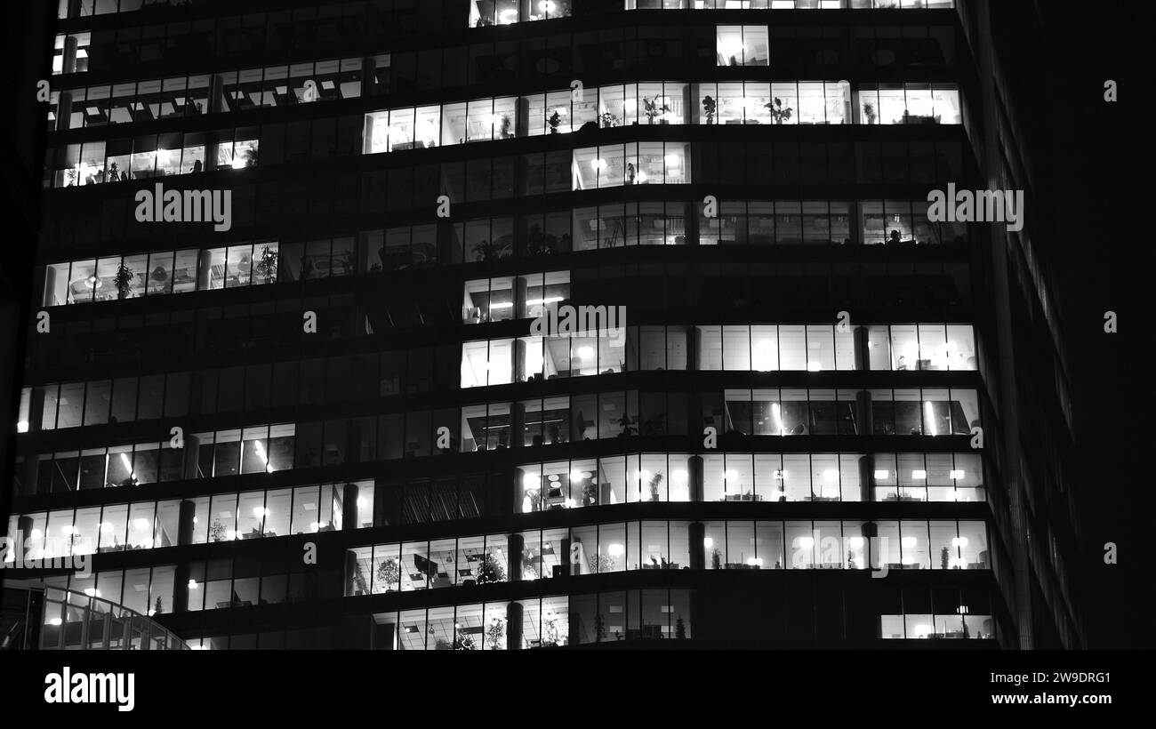 Pattern of office buildings windows illuminated at night. Glass ...
