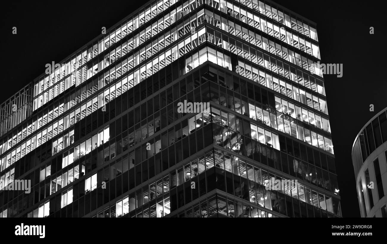 Pattern of office buildings windows illuminated at night. Glass ...