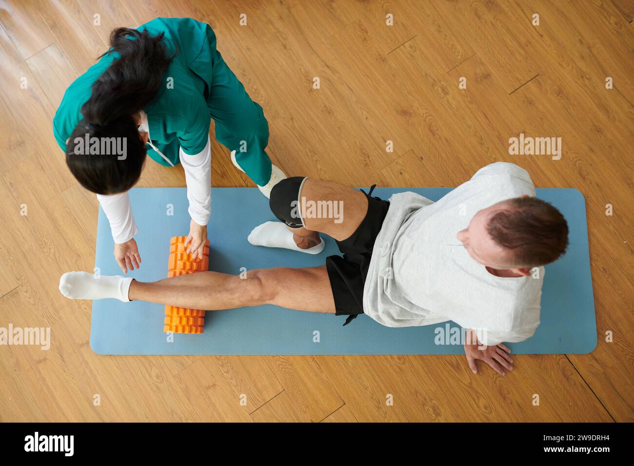 Man with leg injury learning how to do myofascial release with foam ...
