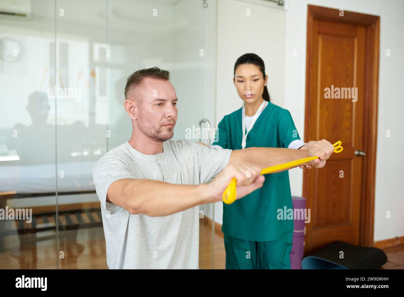 Man attending physiotherapy in medical center Stock Photo - Alamy