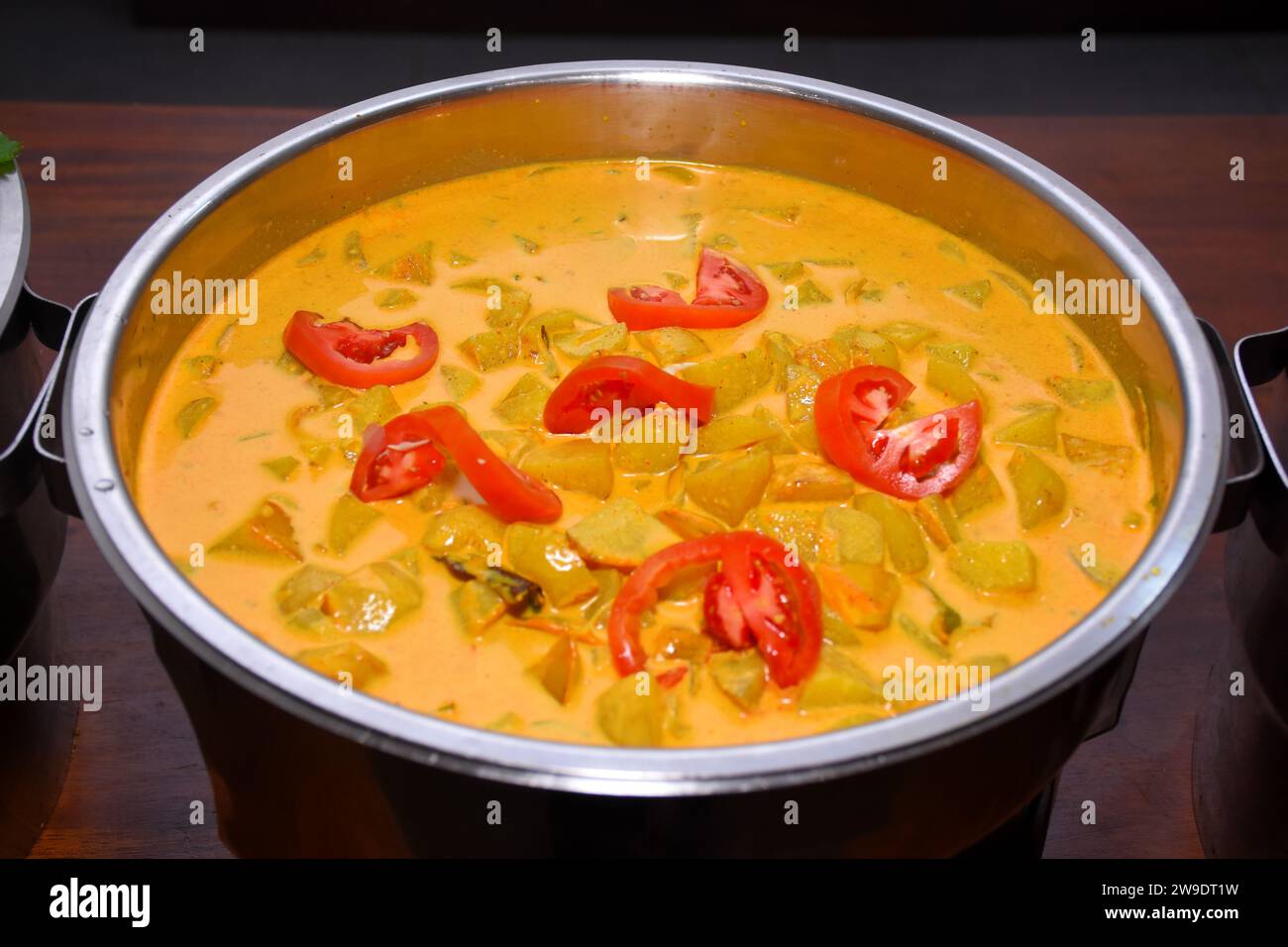 potato Simmering yellow curry in a pan with tomato Stock Photo - Alamy