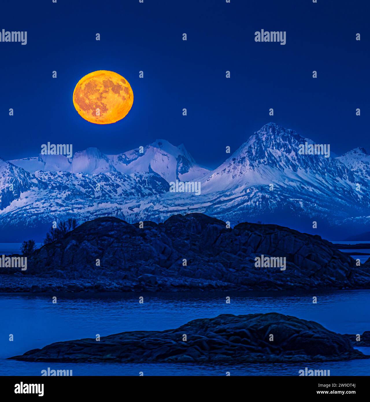 Large supermoon rising behind the majestic mountains of Lofoten ...