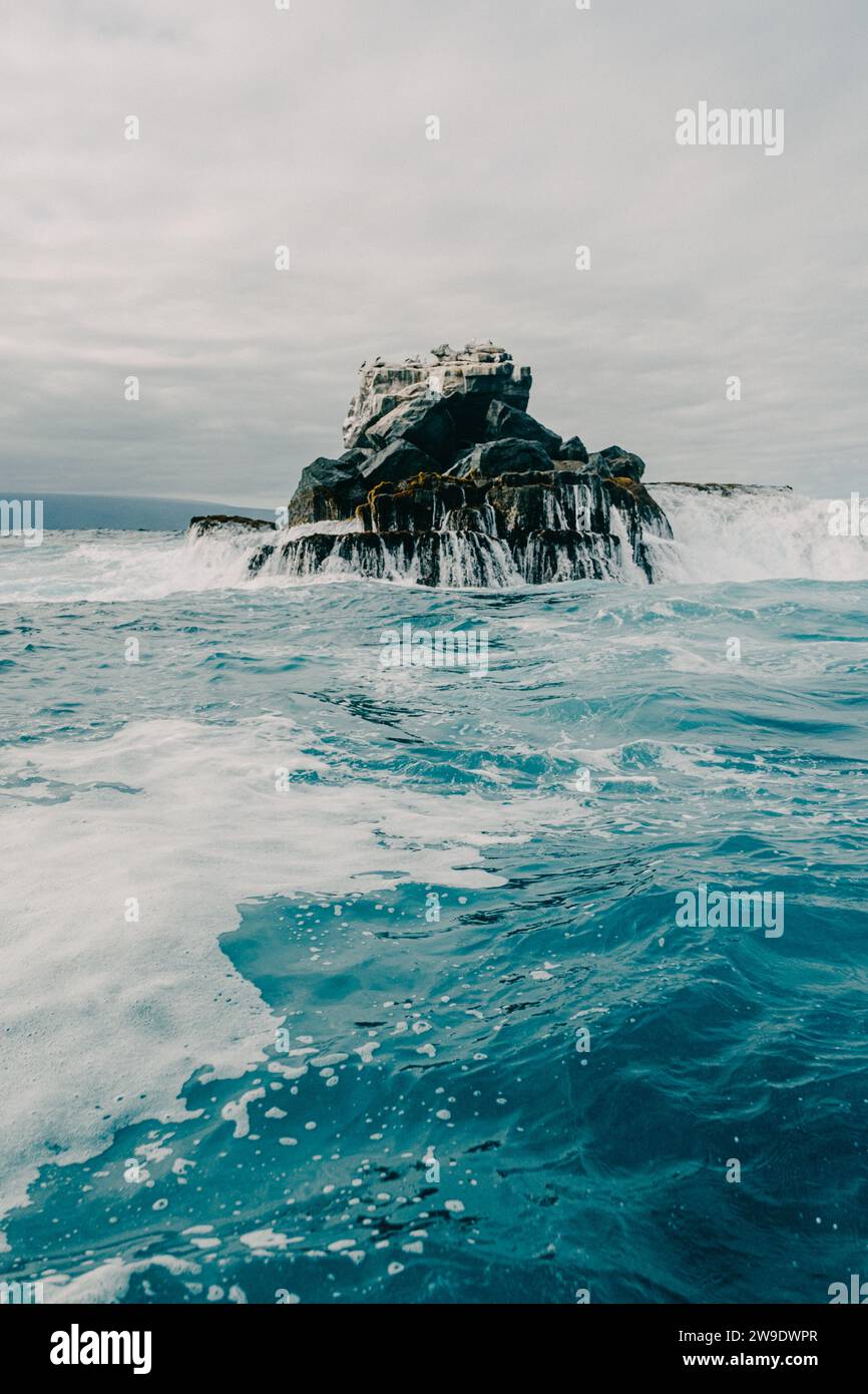 Rocky outcrop with seabirds and waves crashing at Los Tuneles, Isla ...