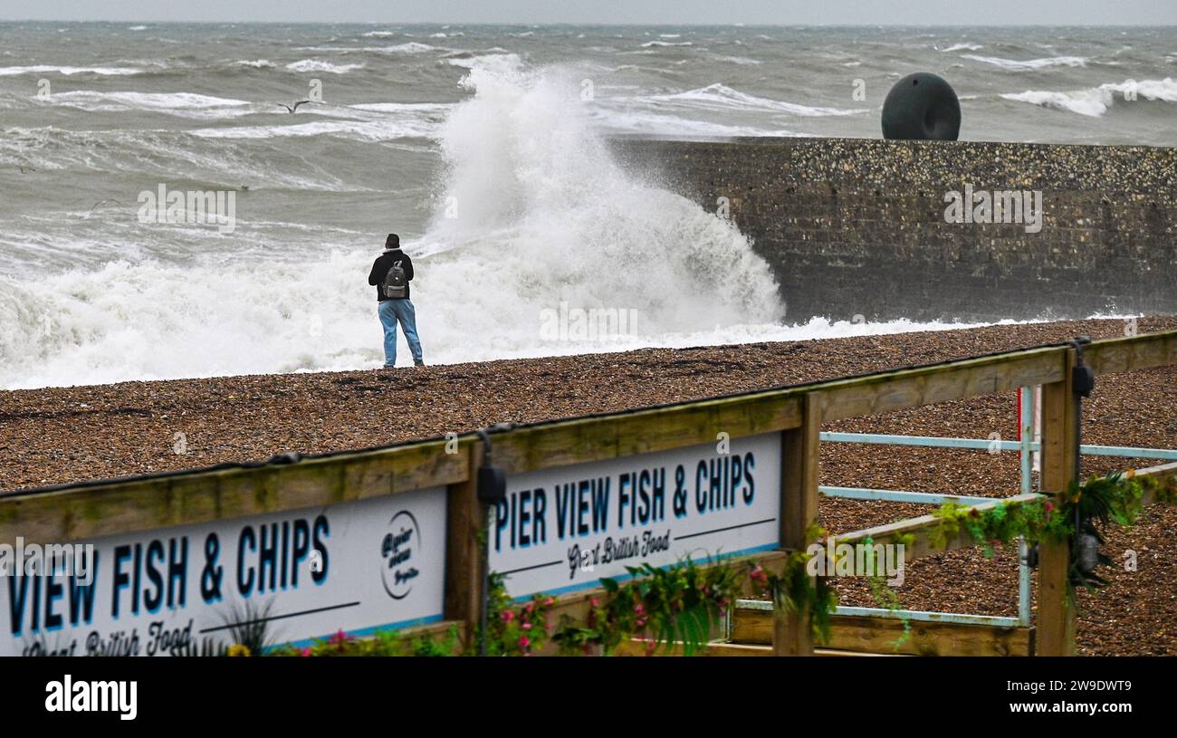 Brighton UK 27th December 2023 - Visitors watch as waves crash onto ...