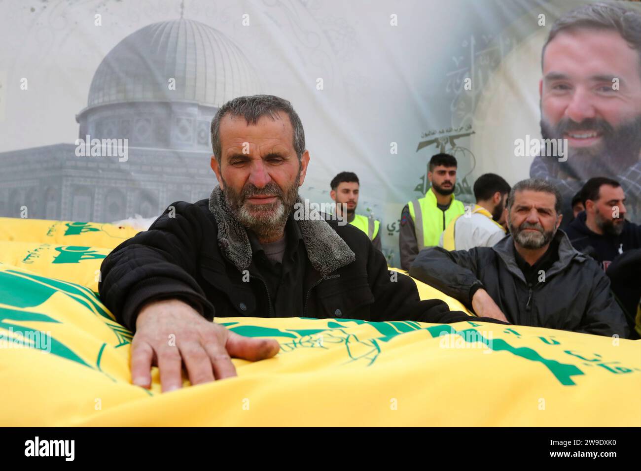 Ahmad Bazzi, the father of a Hezbollah fighter mourns over one of his ...
