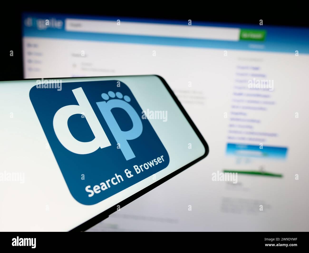 Cellphone with logo of metasearch engine Dogpile in front of business ...