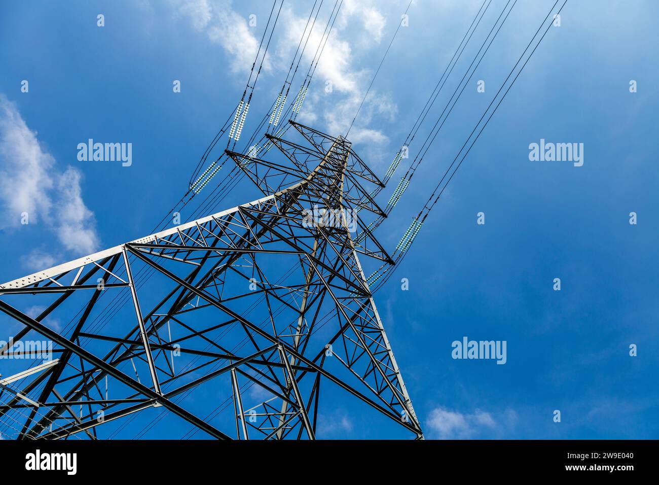 Electricity pylon against a blue sky, London, UK Stock Photo - Alamy