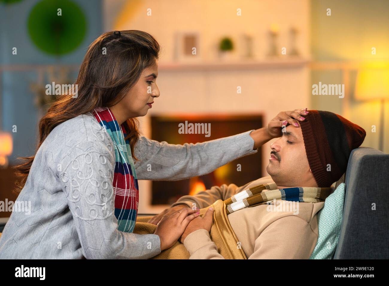 Worried caring wife comforting sick husband at home during winter - concept of relationship ...