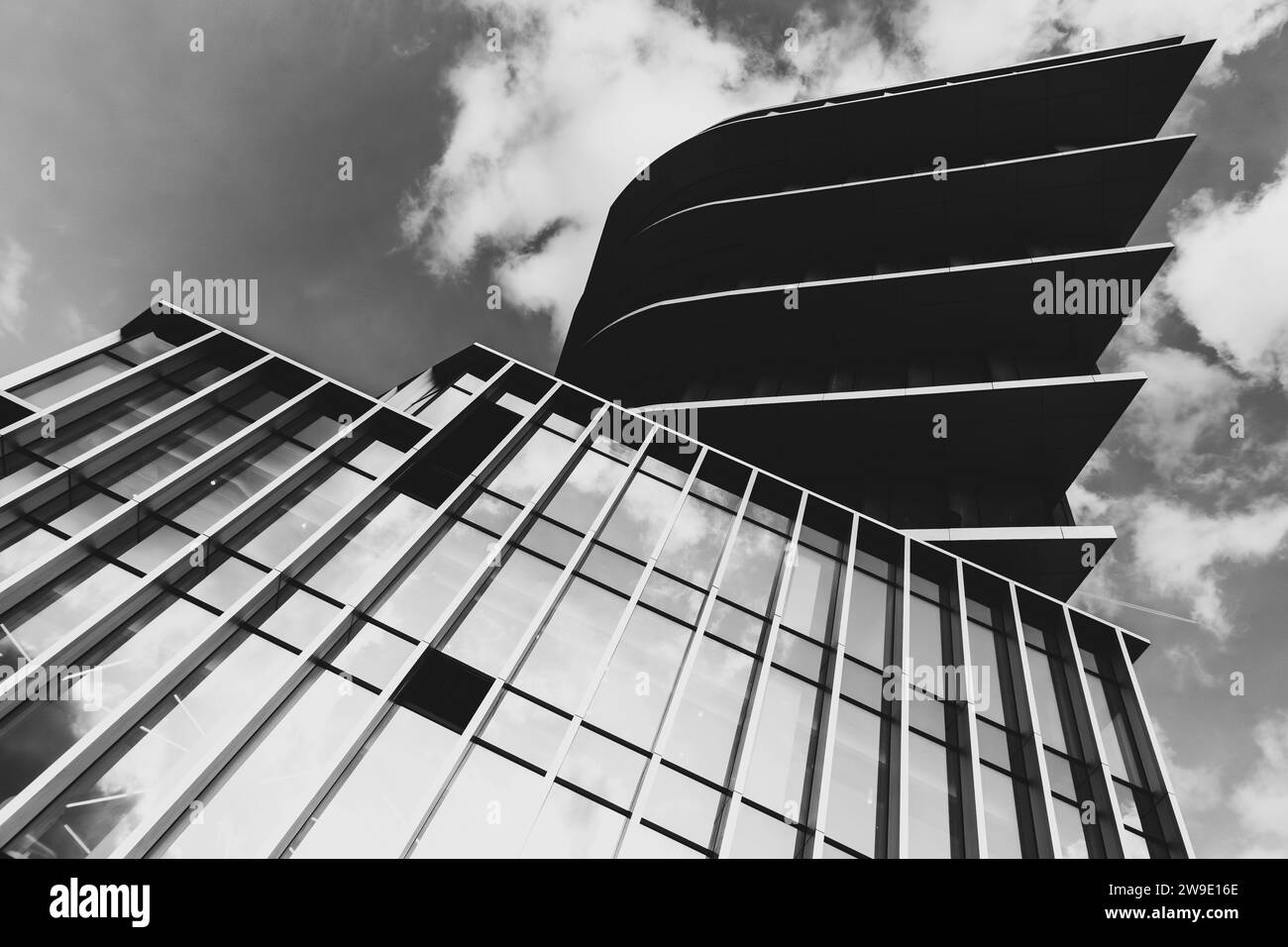 Stark black and white contrast of a modern building with a dynamic sky ...