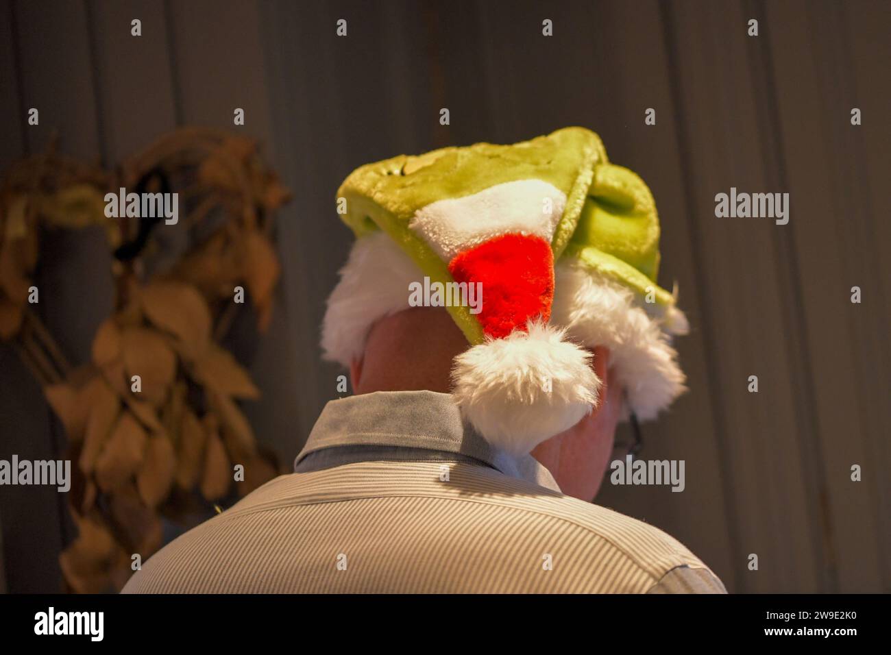 A festive Grinch Christmas Hat on the head of a man, picture from the ...