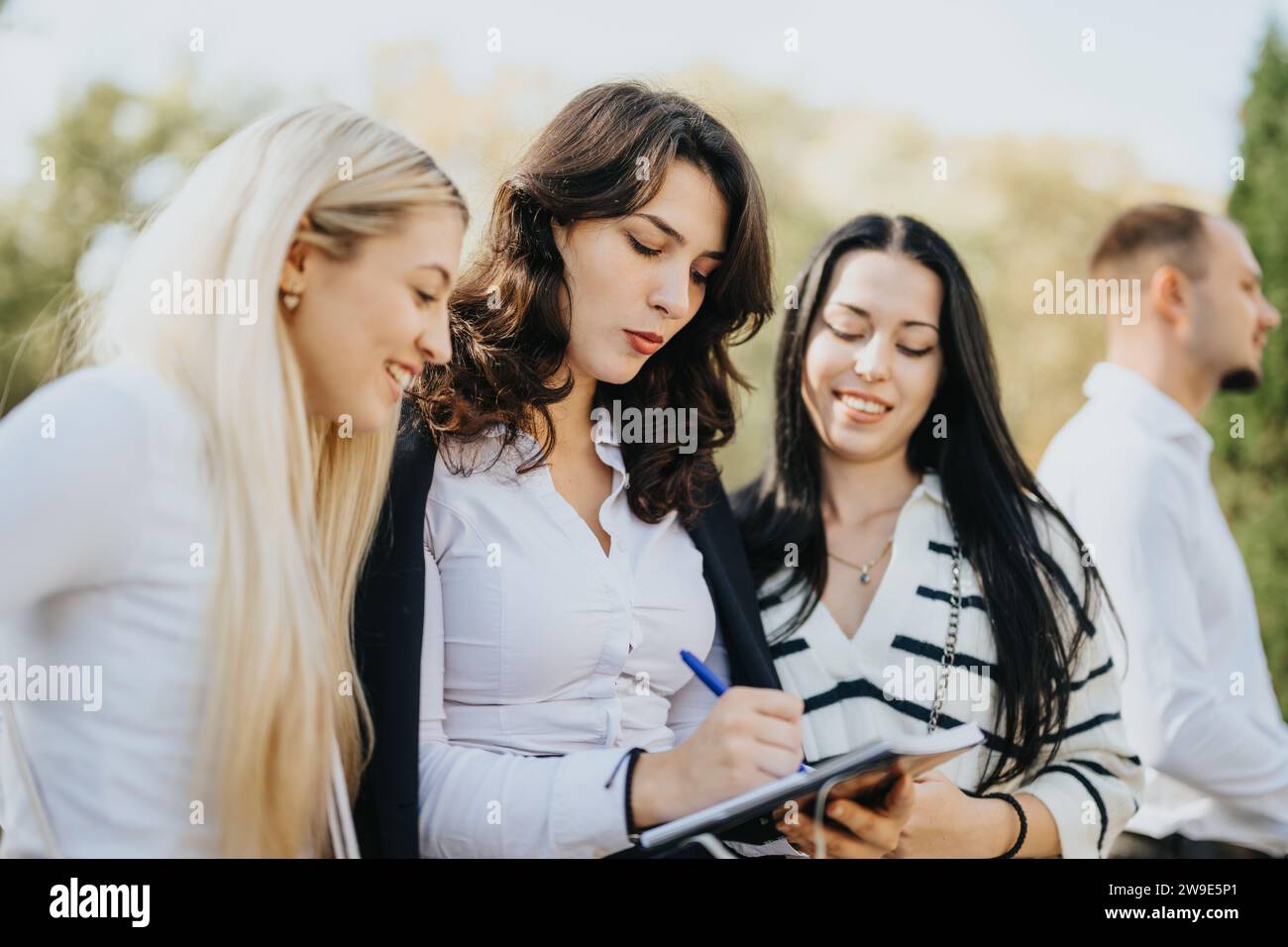 Motivated University Students Collaborating in a Sunny Park, Achieving ...