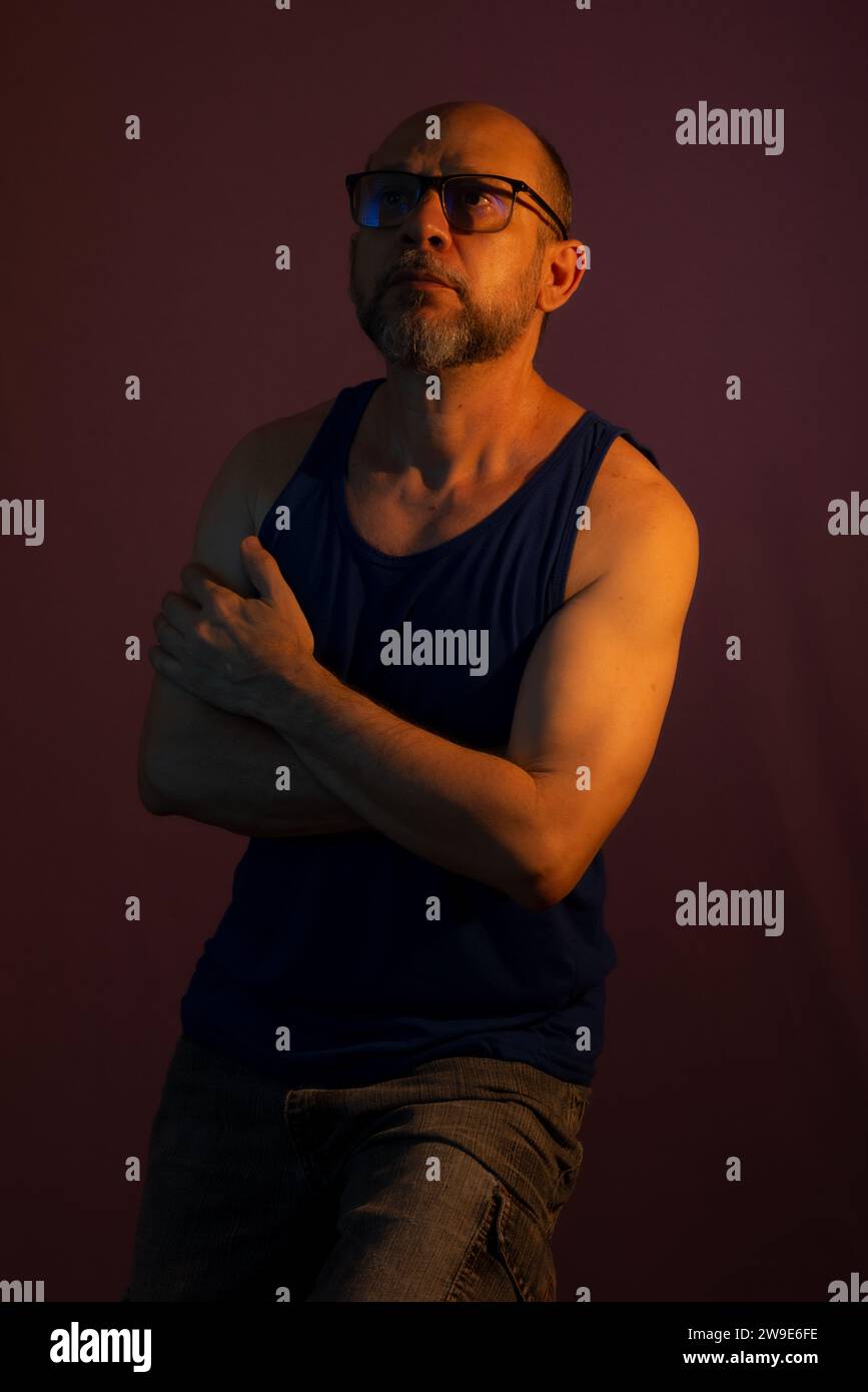 Portrait Of Bearded Bald Man Wearing Prescription Glasses With Blue