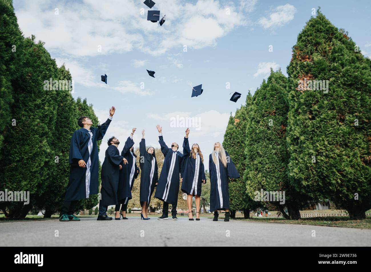 Successful Graduates Celebrating Achievements with Friends in Park ...