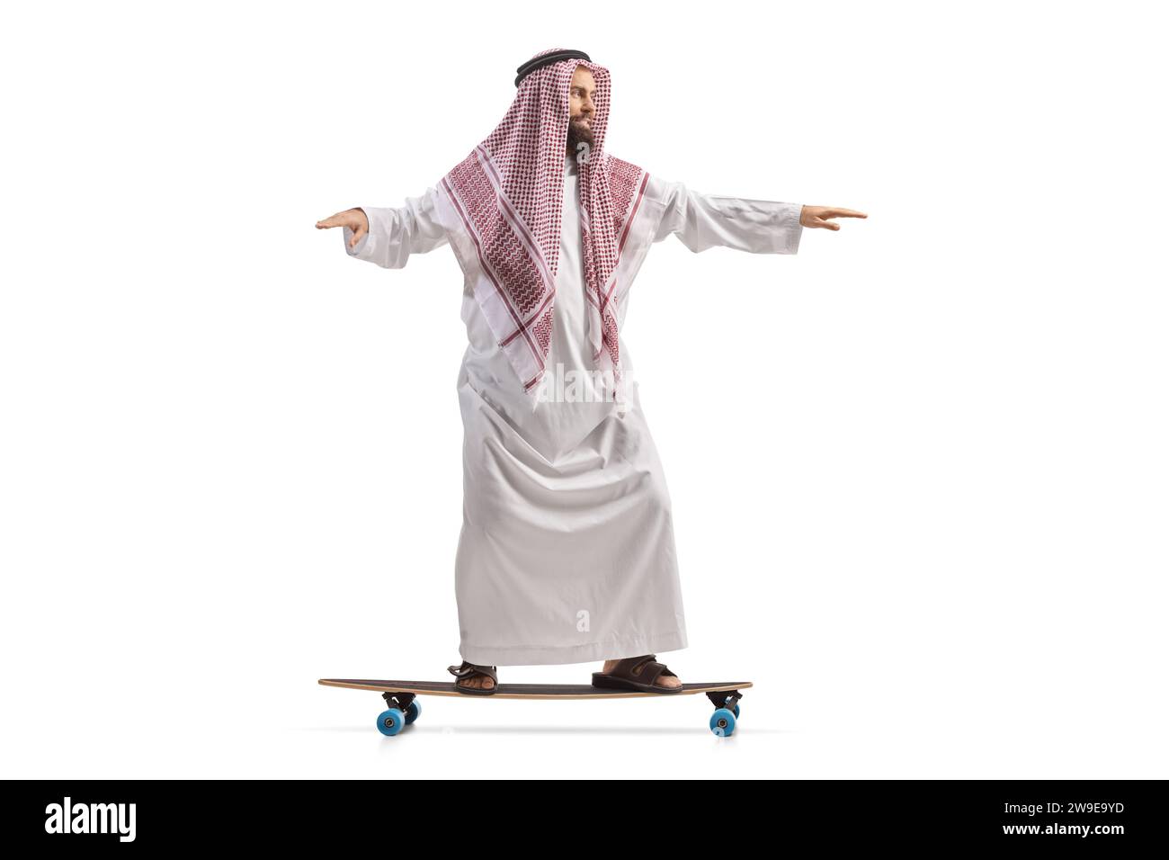 Saudi arab man in ethnic robe riding a skateboard isolated on white ...
