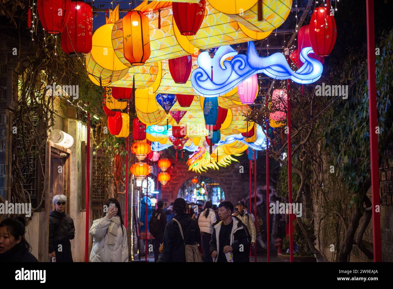 Nanjing, China. 27th Dec, 2023. Tourists are viewing lanterns at the ...