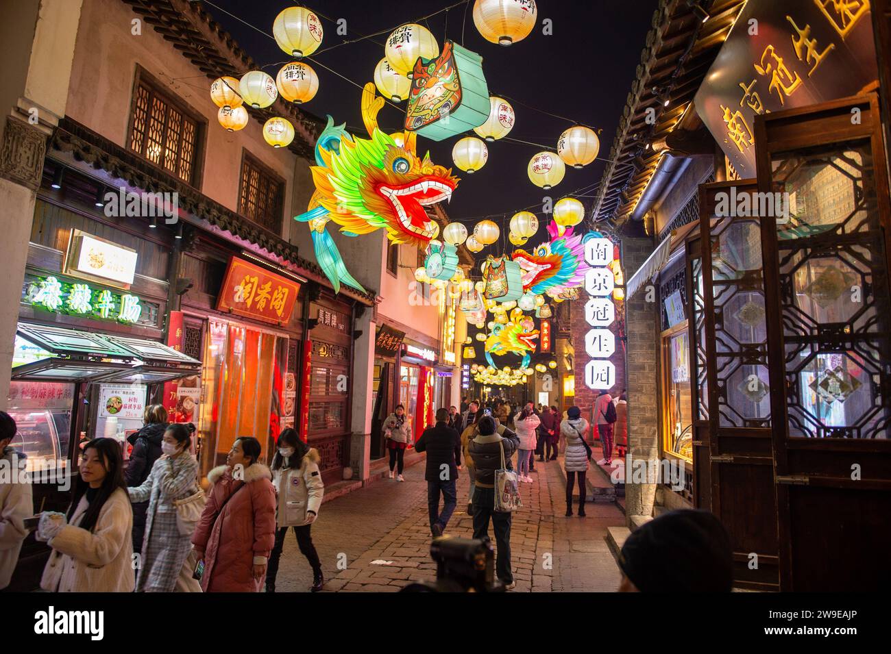 Nanjing, China. 27th Dec, 2023. Tourists are viewing lanterns at the ...