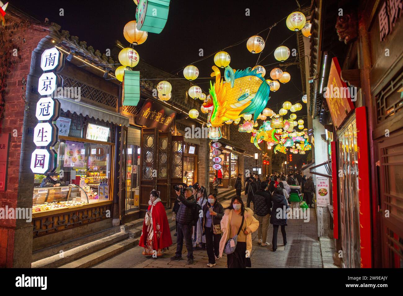 Nanjing, China. 27th Dec, 2023. Tourists are viewing lanterns at the ...