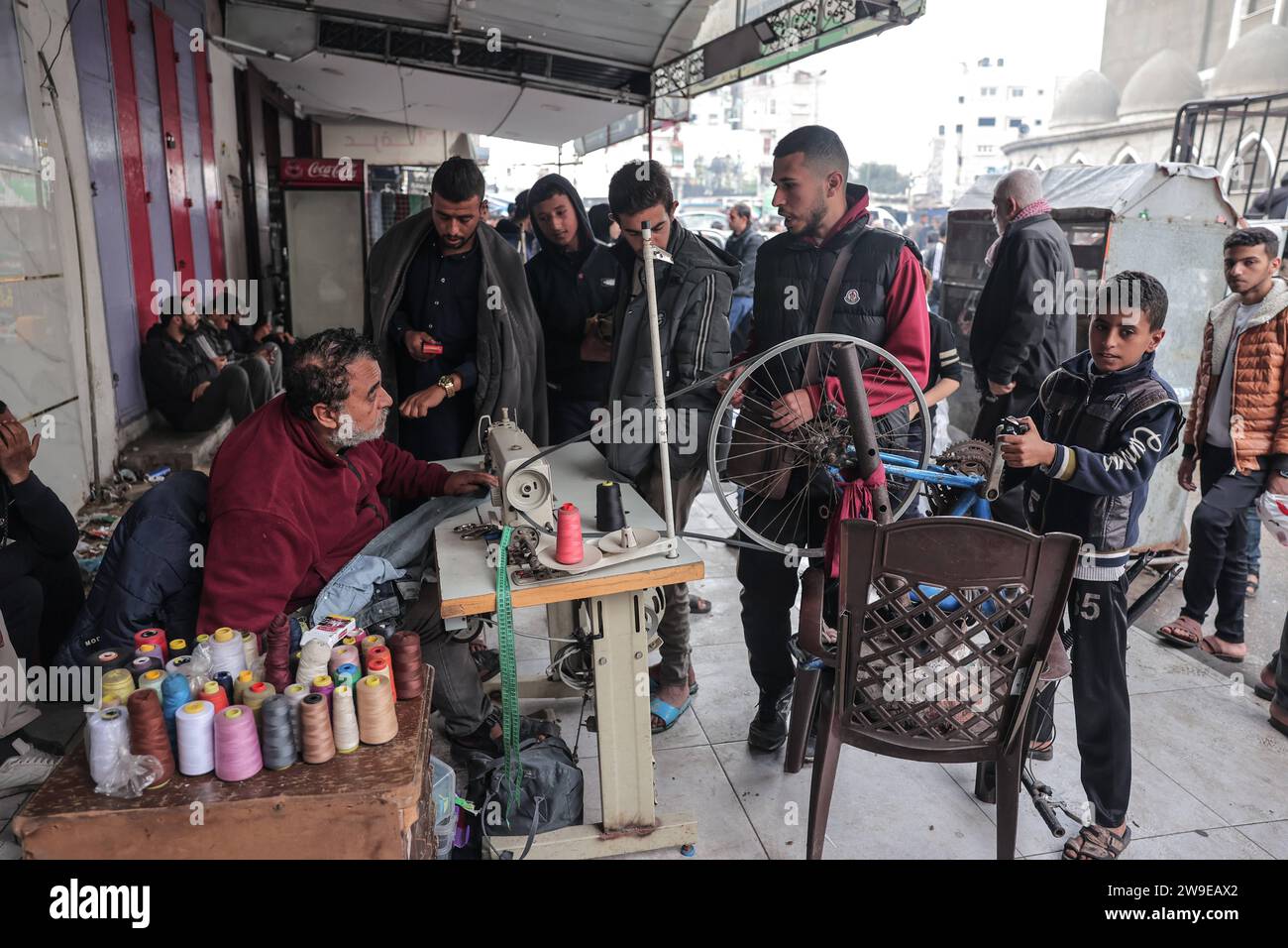 A Palestinian tailor named Abu Adam Dolah, uses a pedaled sewing ...