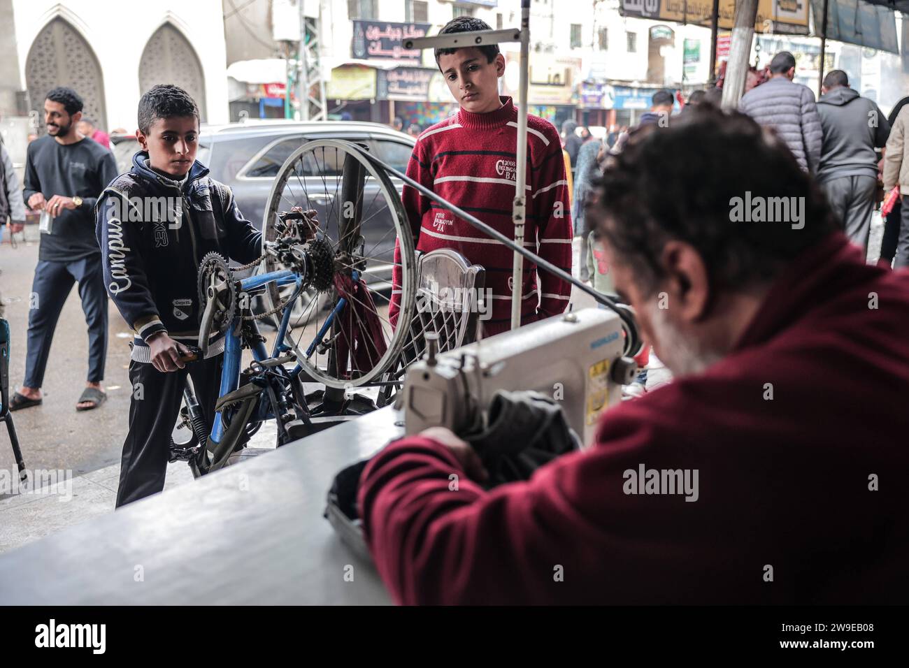 A Palestinian tailor named Abu Adam Dolah, uses a pedaled sewing ...