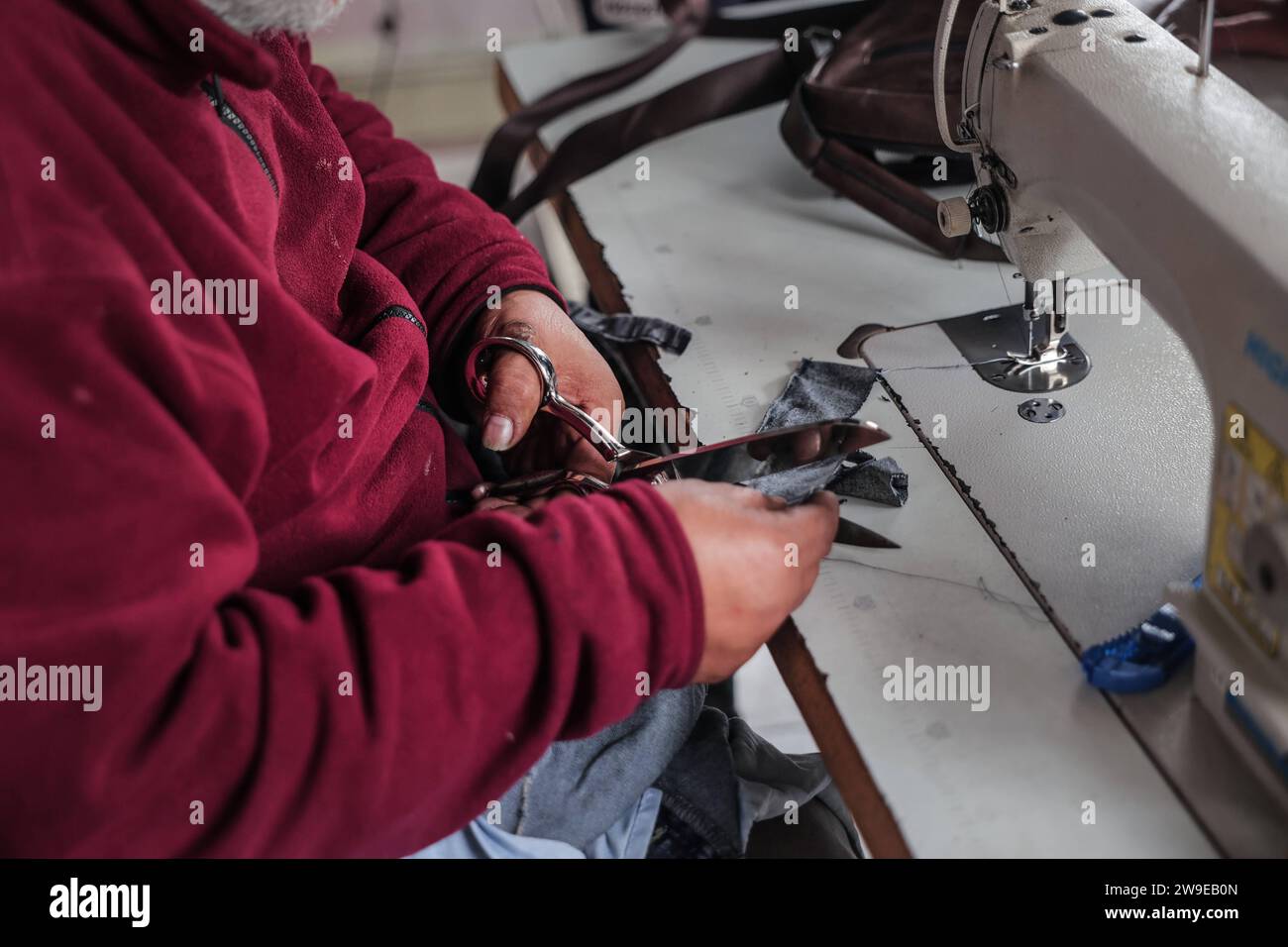 A Palestinian tailor named Abu Adam Dolah, uses a pedaled sewing ...