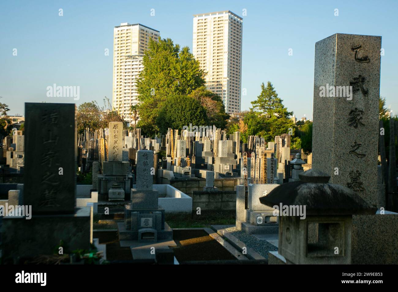 Tokyo, Japan; 1st October 2023: Yanaka Cemetery with buildings in the ...