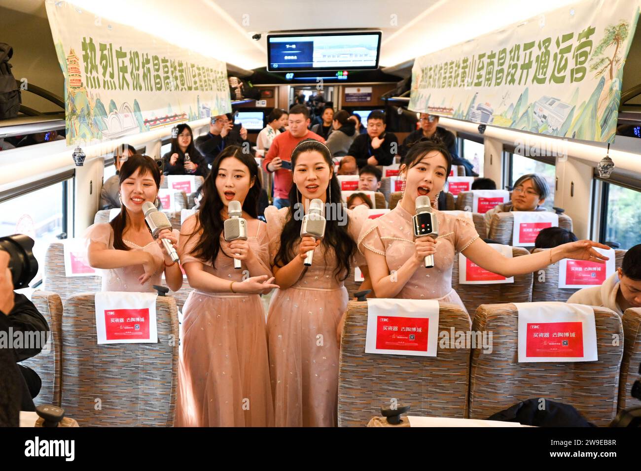 Nanchang, China. 27th Dec, 2023. Passengers are watching a performance ...