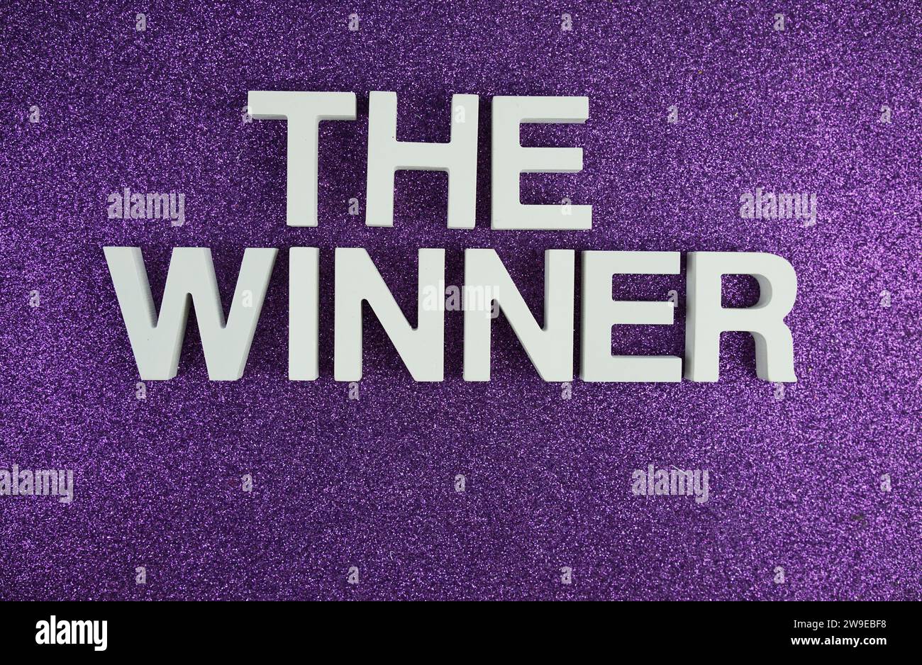 The Winner alphabet letters top view on purple glitter background Stock ...