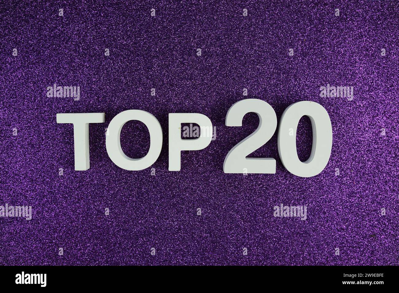 Top 20 alphabet letters top view on purple glitter background Stock ...