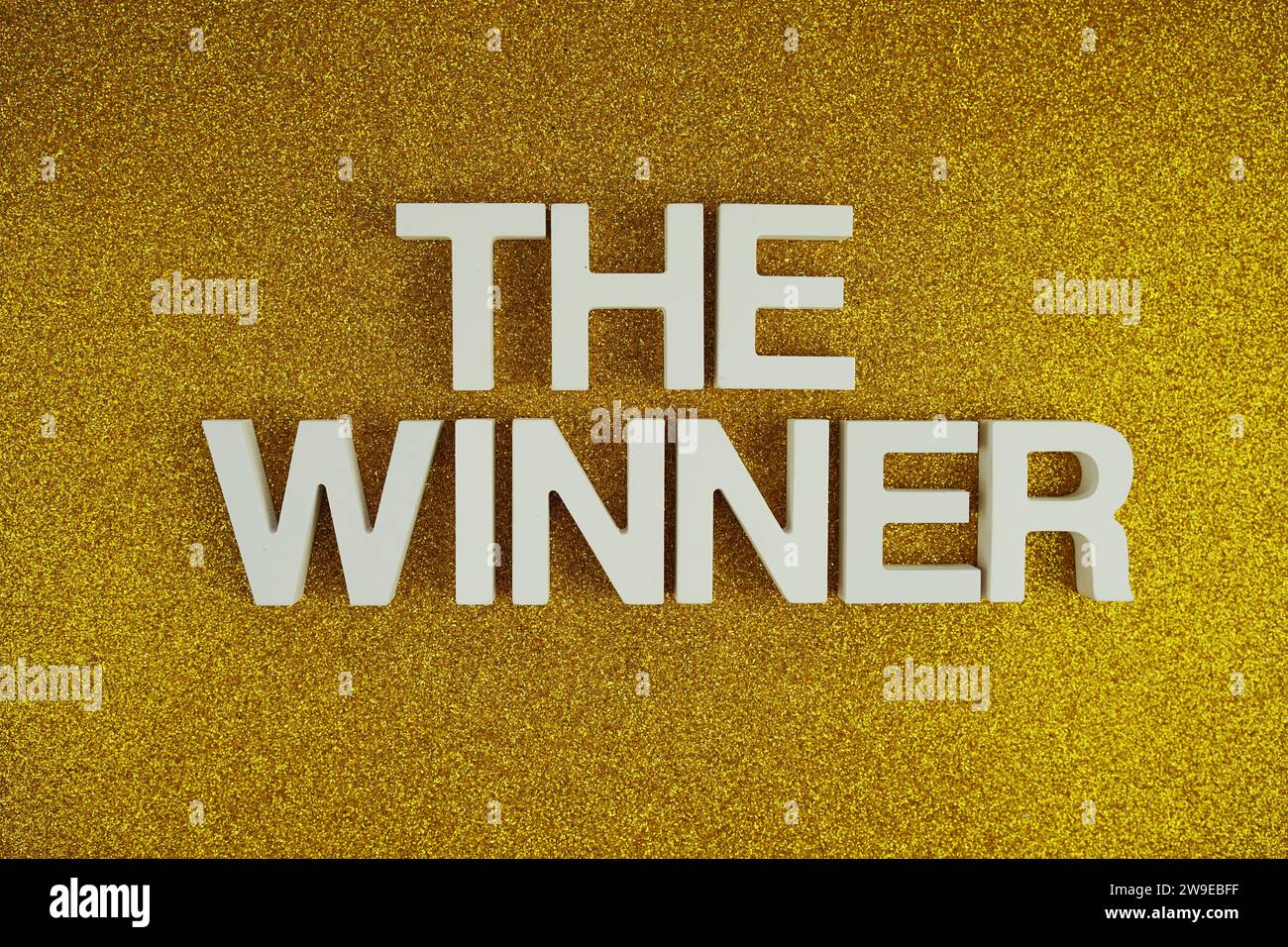 The Winner alphabet letters top view on yellow glitter background Stock ...