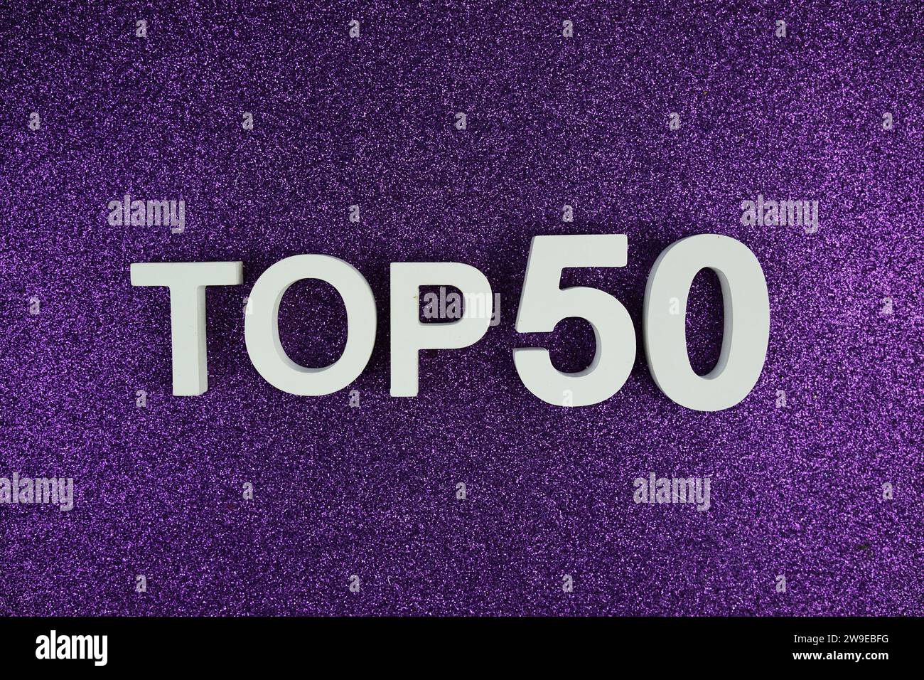 Top 50 alphabet letters top view on purple glitter background Stock ...