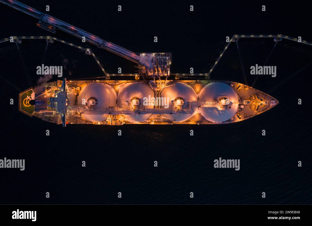 Aerial of Liquified Natural Gas LNG carrier moored to a small gas ...