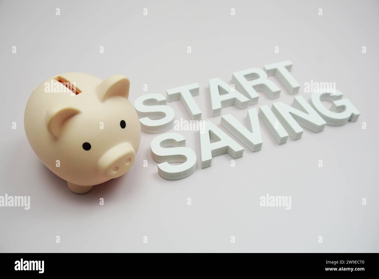 Start Saving alphabet letters and piggy bank with space copy on pink ...